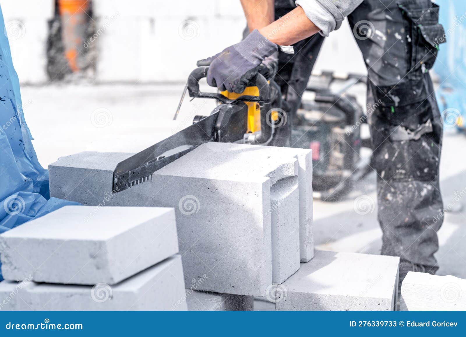Cutting Concrete Blocks with a Saw during the Construction of a ...