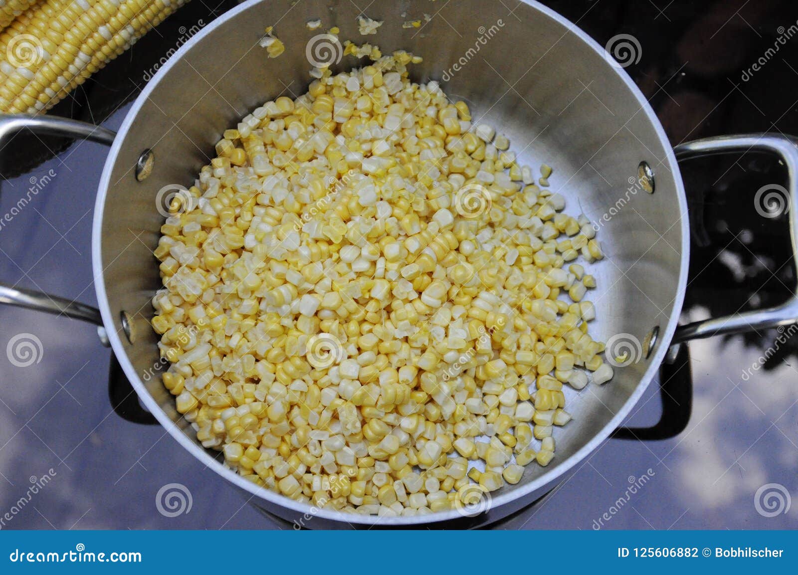 Cutting corn of the cob stock photo. Image of canada - 125606882