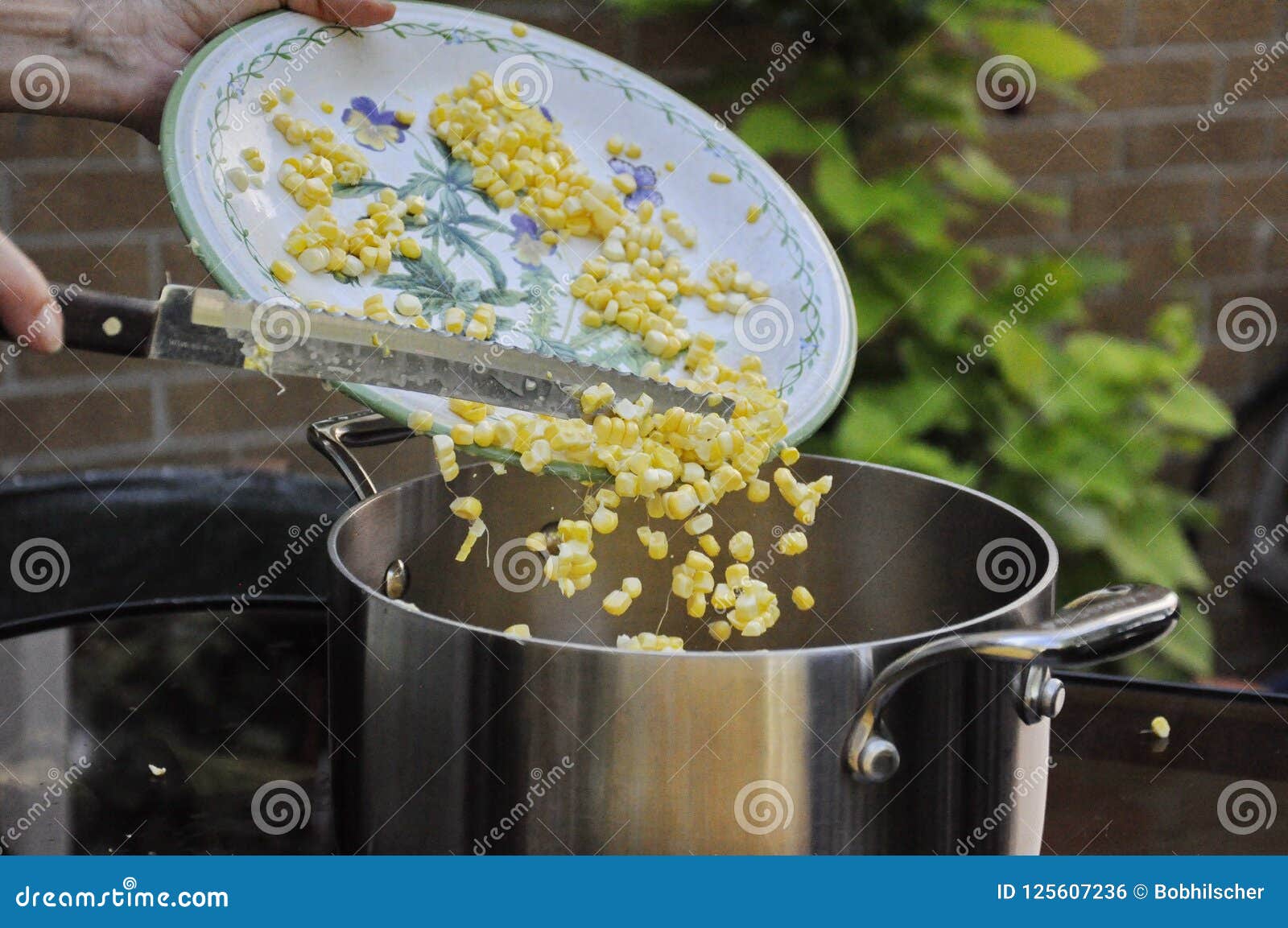 Cutting corn of the cob stock photo. Image of fresh - 125607236