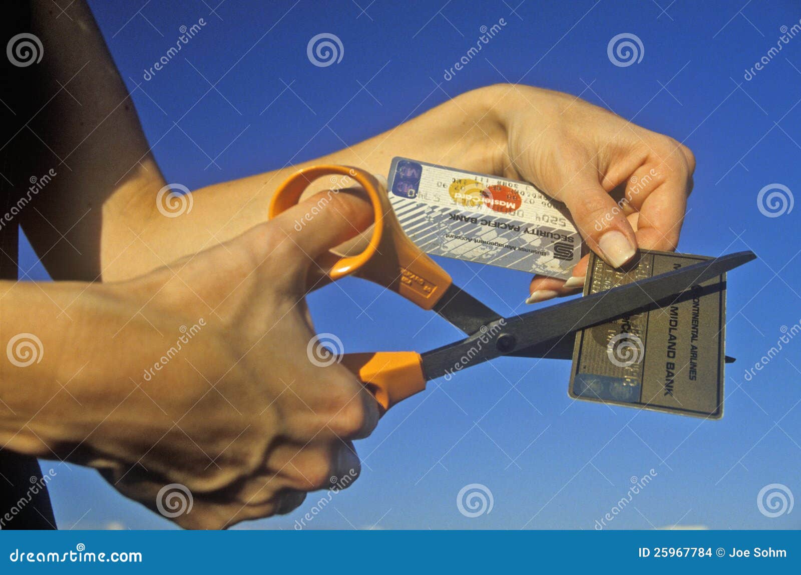 Cutting the credit cards editorial stock image. Image of hands - 25967784
