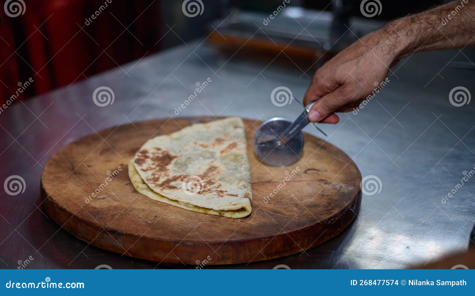 Cutting a Folded Tortilla with a Roti Cutter by the Chef in a ...