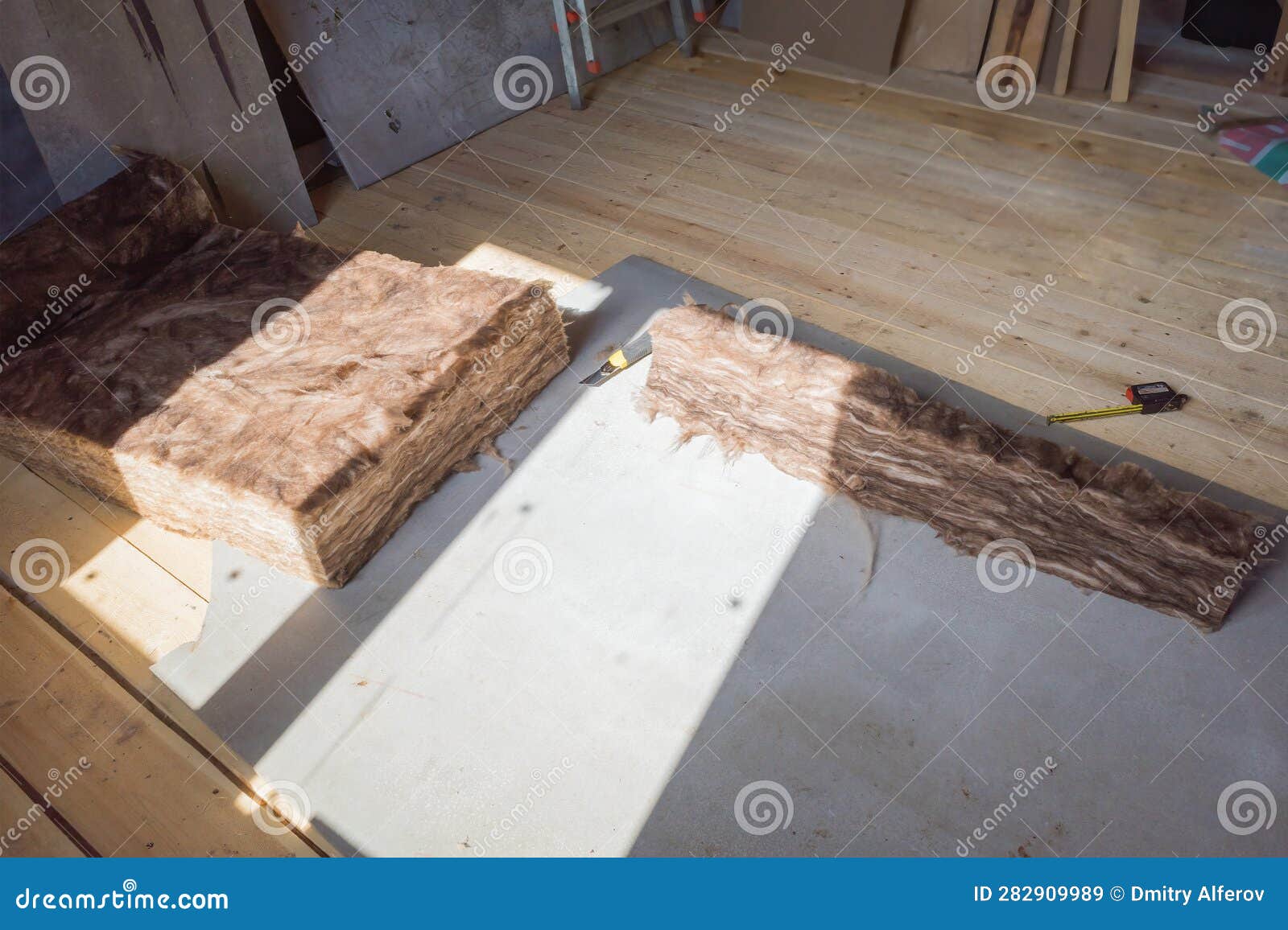 Cutting Insulation for Laying in a Frame House Under Construction ...