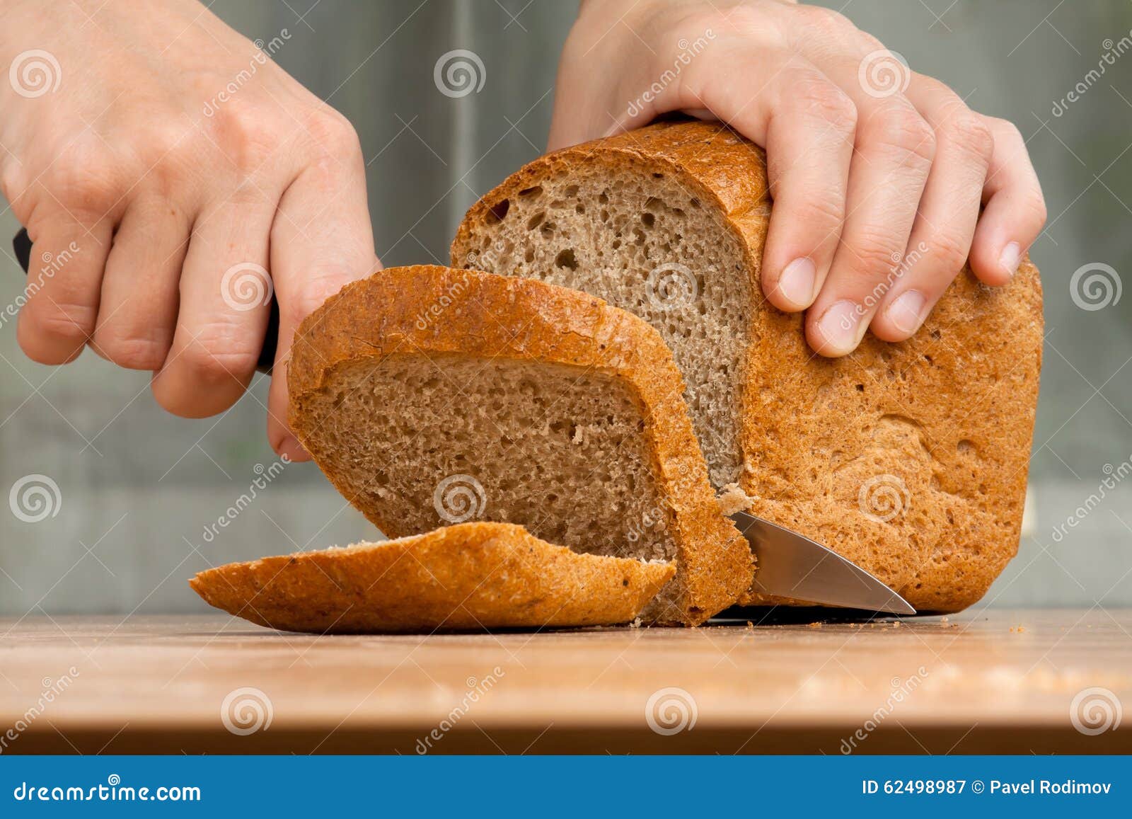 Cutting a loaf of bread stock image. Image of closeup - 62498987