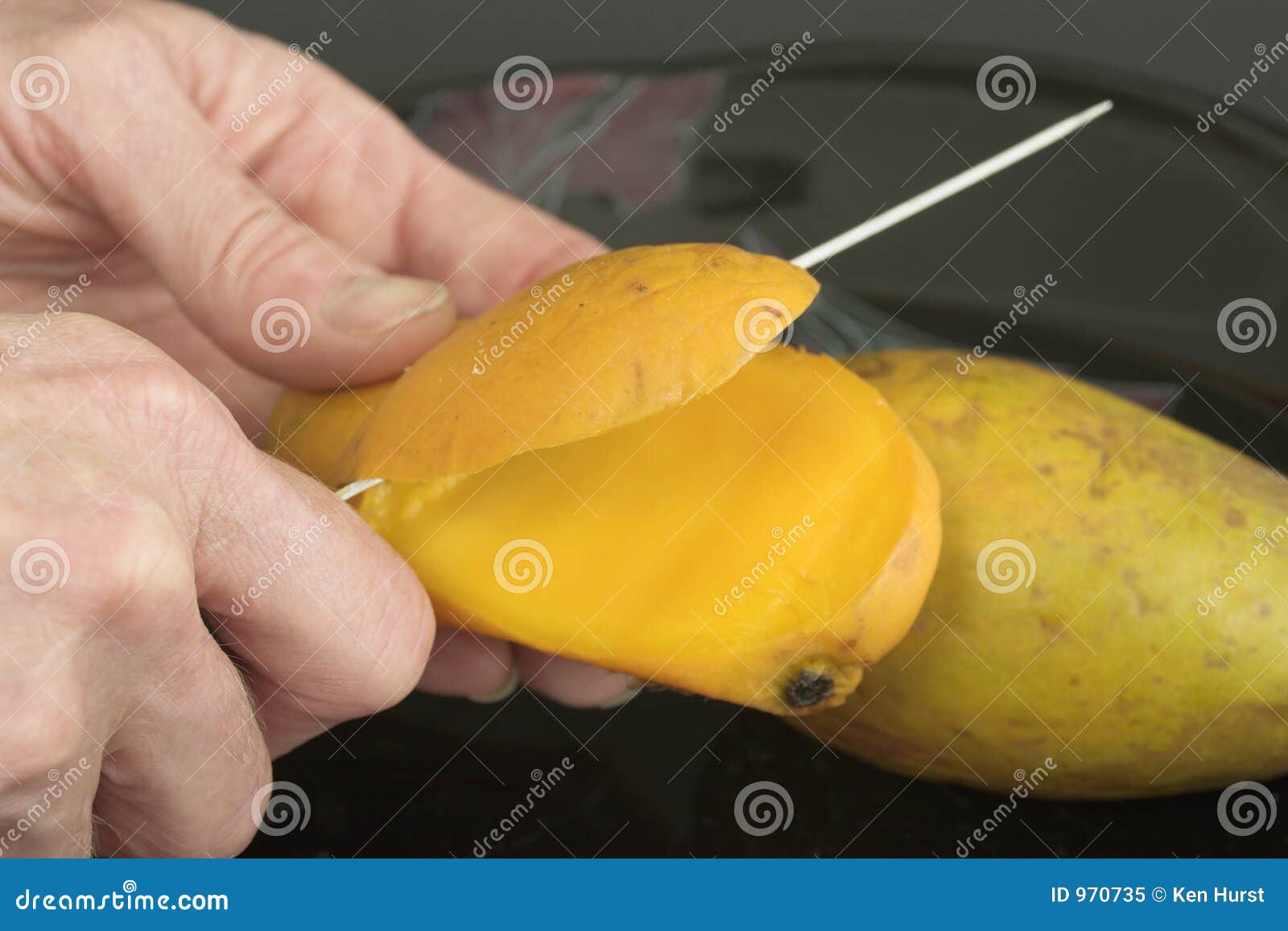 Cutting a Mango 2 stock image. Image of hands, hand, fruit - 970735