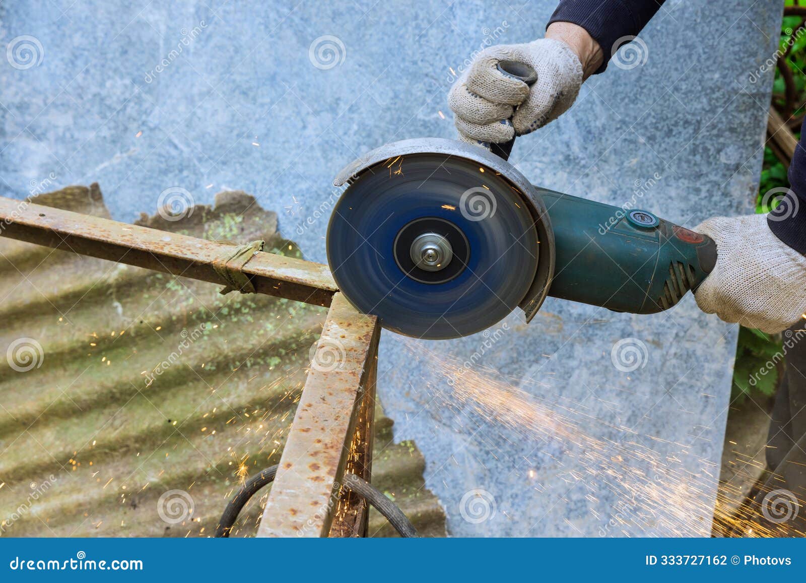 During Cutting of Metal Frames, a Worker Uses an Angle Grinder Hand Saw ...