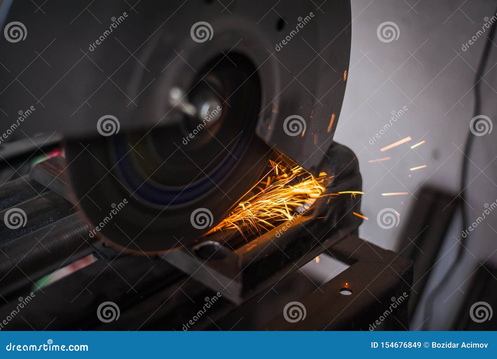 Cutting Metal with Grinder in Workshop. Sparks while Grinding Iron ...