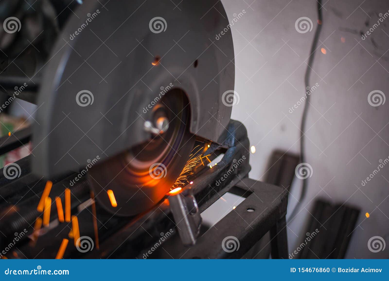 Cutting Metal with Grinder in Workshop. Sparks while Grinding Iron ...