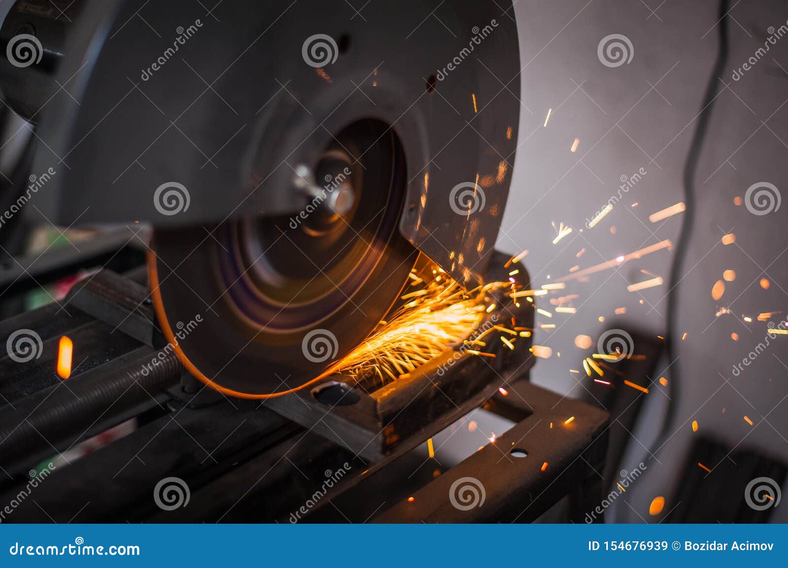 Cutting Metal with Grinder in Workshop. Sparks while Grinding Iron ...