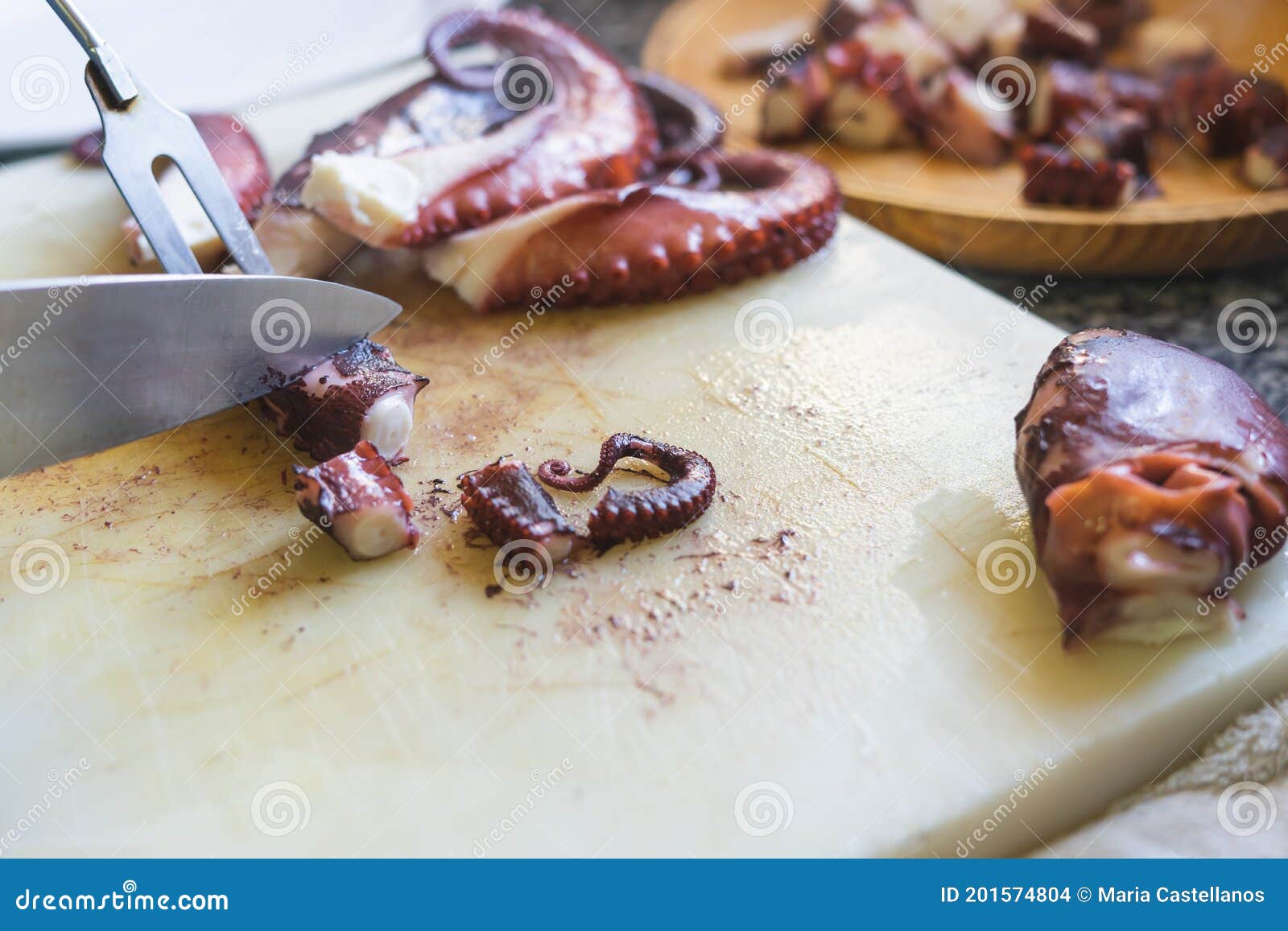 Cutting Octopus with Knife on Kitchen Table. Concept of Seafood Stock ...