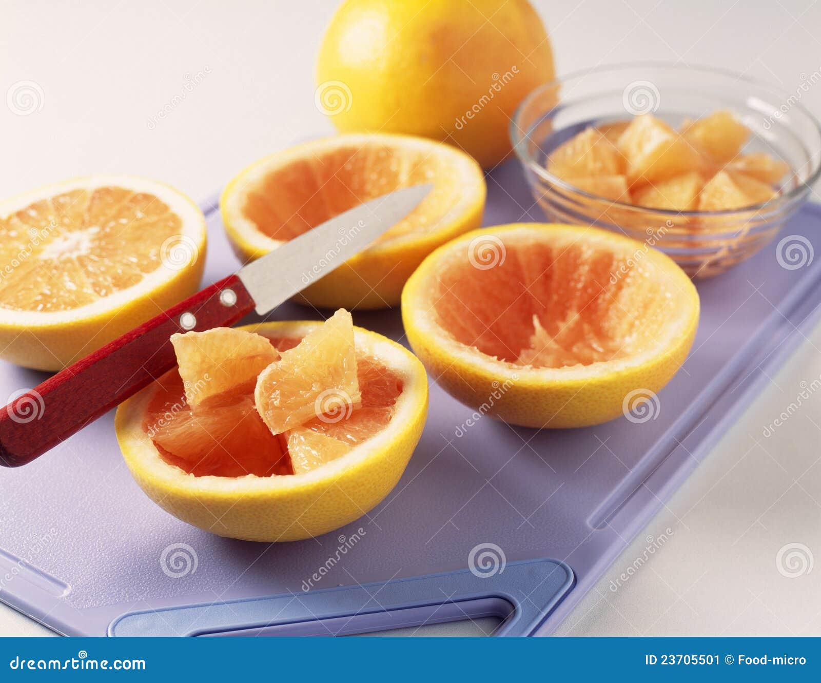 Cutting a pink grapefruit stock image. Image of shell - 23705501
