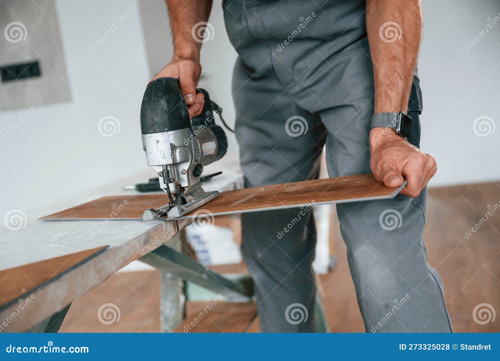 Cutting the Planks. Man is Installing New Laminated Wooden Floor Stock ...