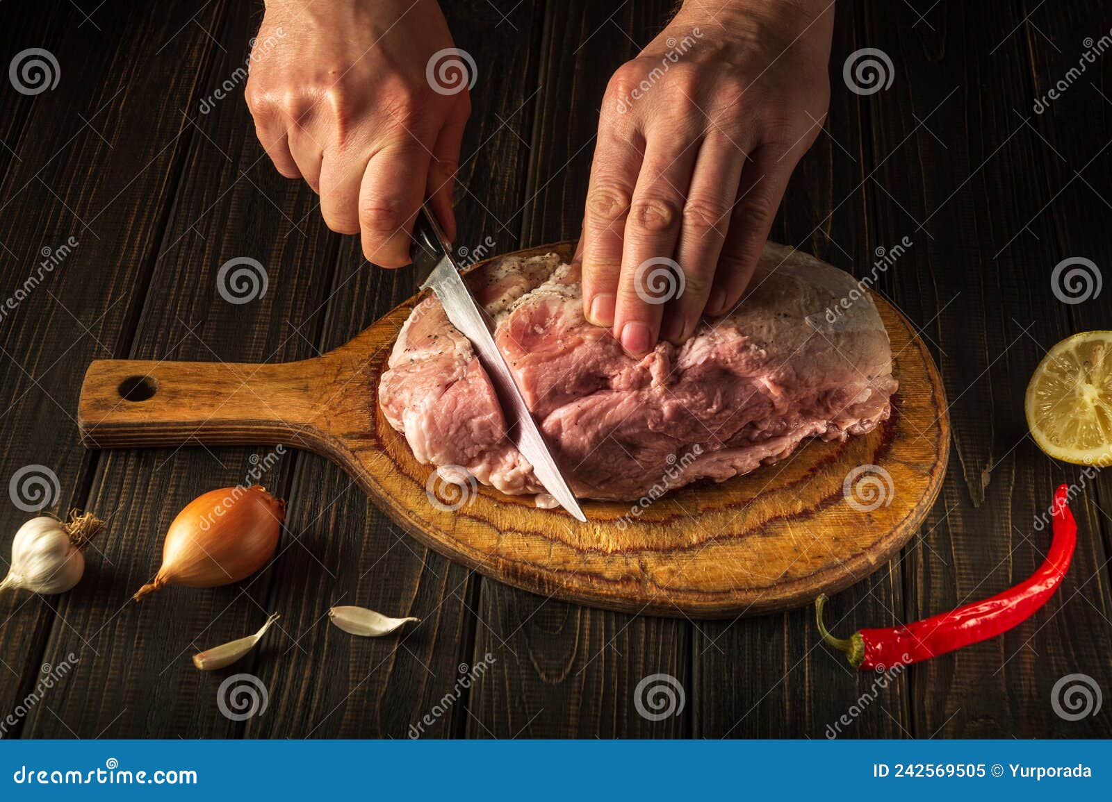 Cutting Raw Meat with a Knife before Grilling in the Kitchen. the Chef ...