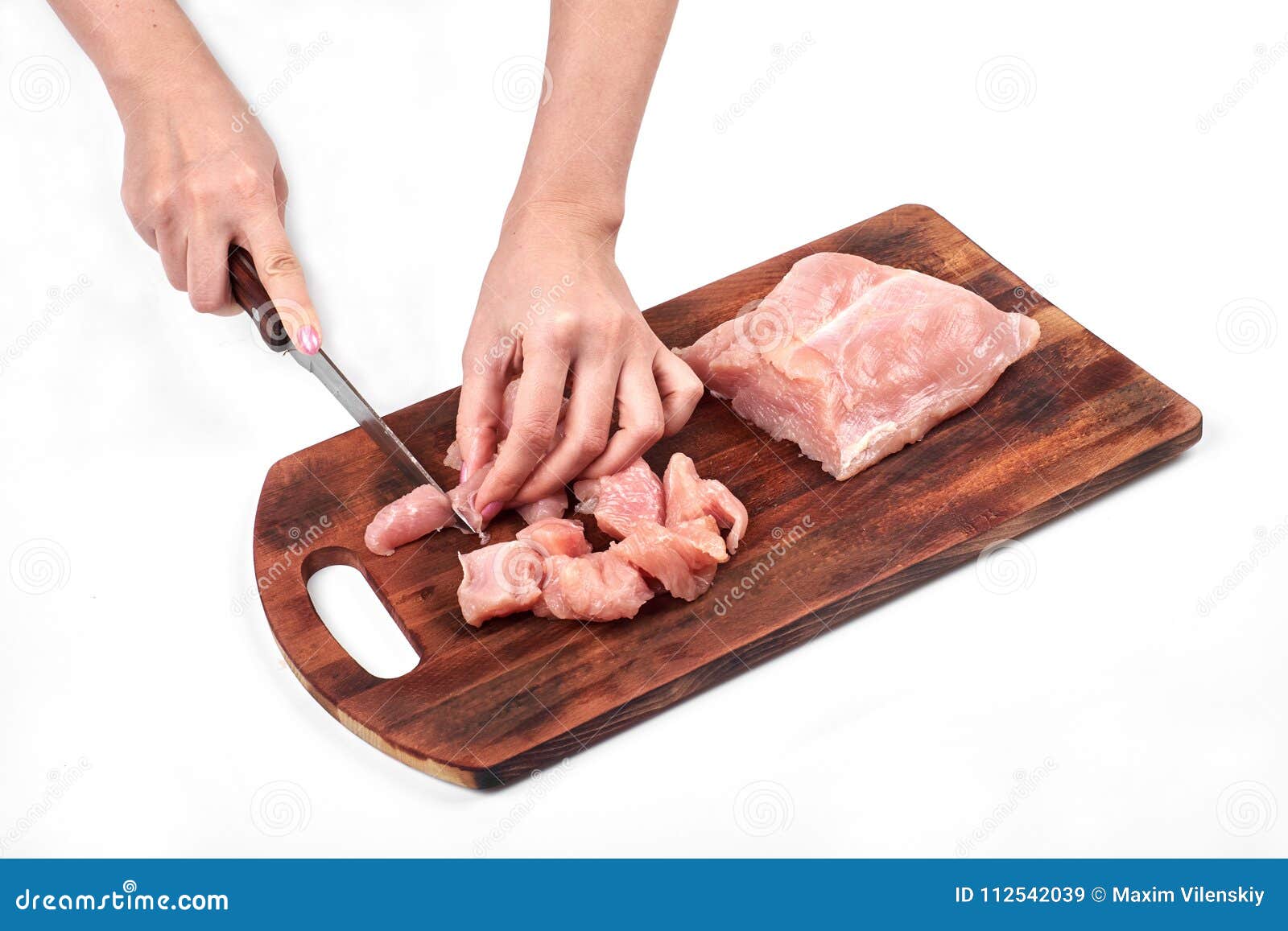 Cutting Raw Turkey Meat with a Kitchen Knife on a Cutting Board on ...