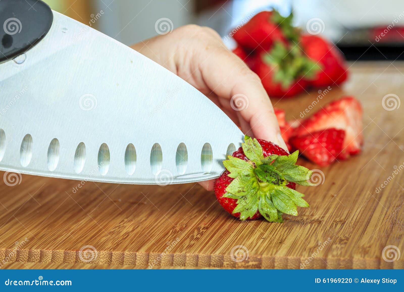 Cutting strawberries stock photo. Image of kitchenware - 61969220