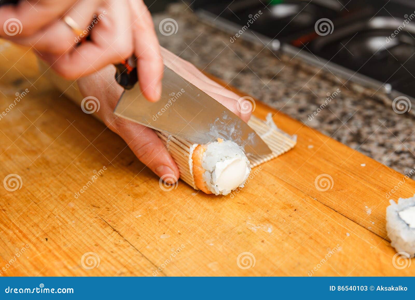 Cutting sushi rolls. stock image. Image of kitchen, meal - 86540103