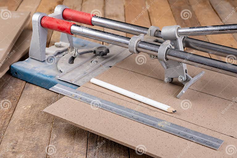Cutting Tiles in a Home Workshop. Tiling Work on a Workshop Table Stock ...