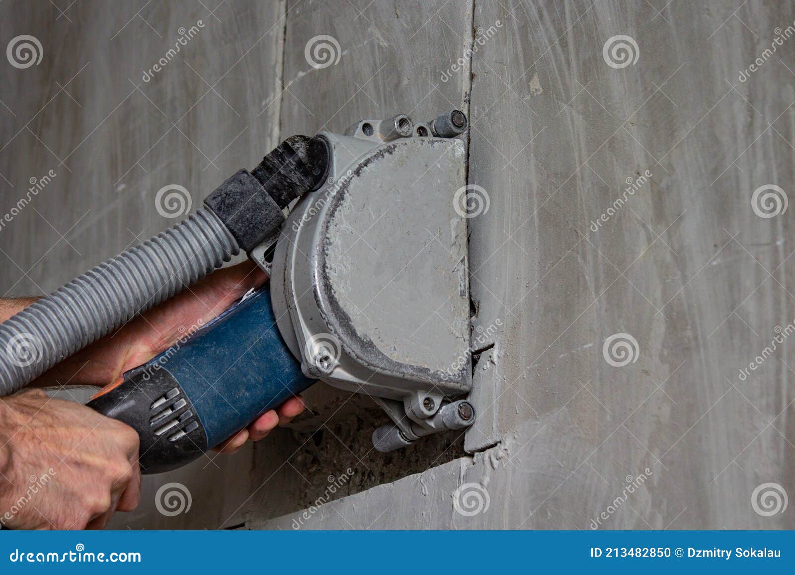 Cutting a Wall with a Power Tool at a Construction Site Using a Vacuum ...