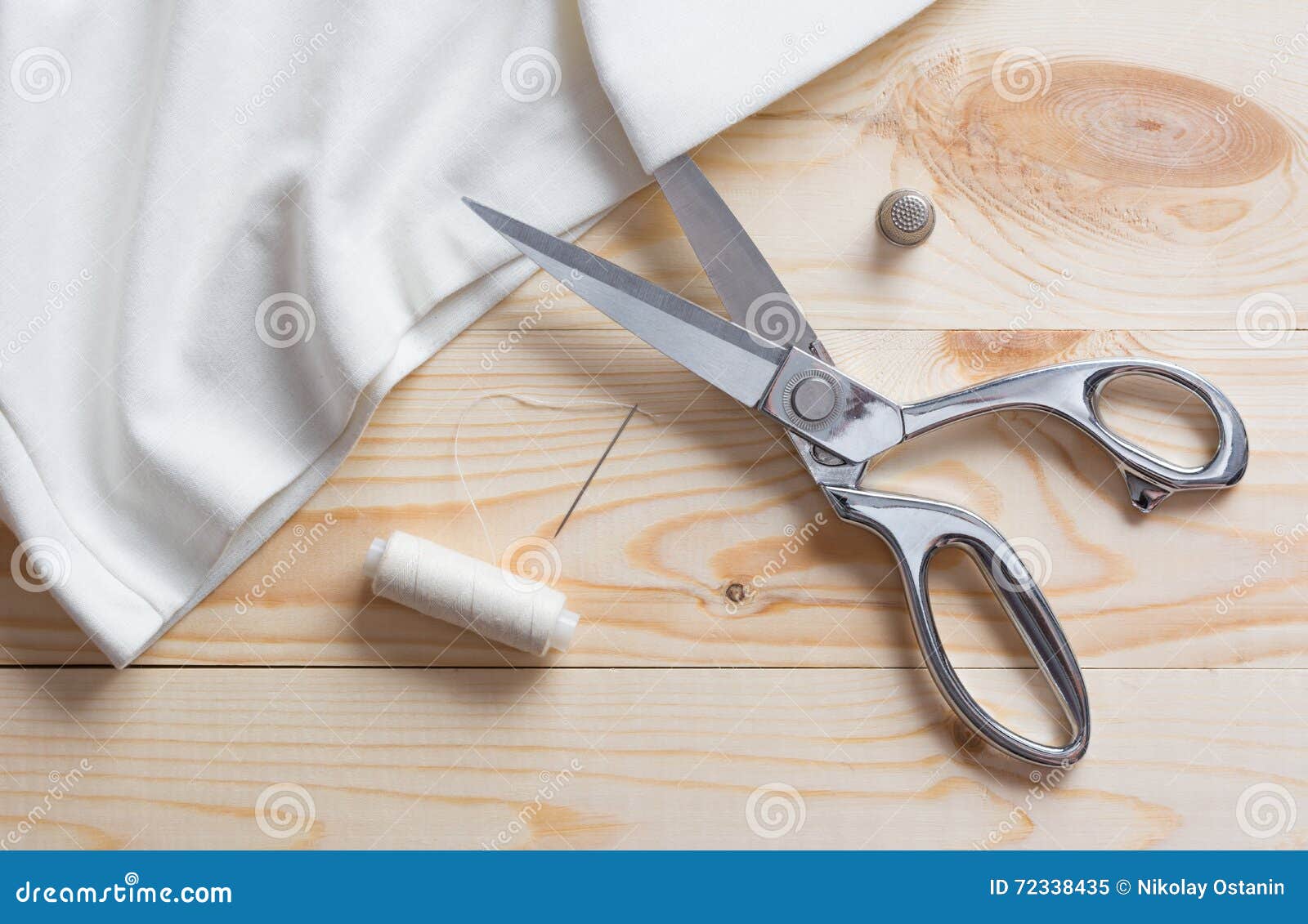 Cutting White Fabric with a Taylor Scissors on Wooden Table Stock Image ...