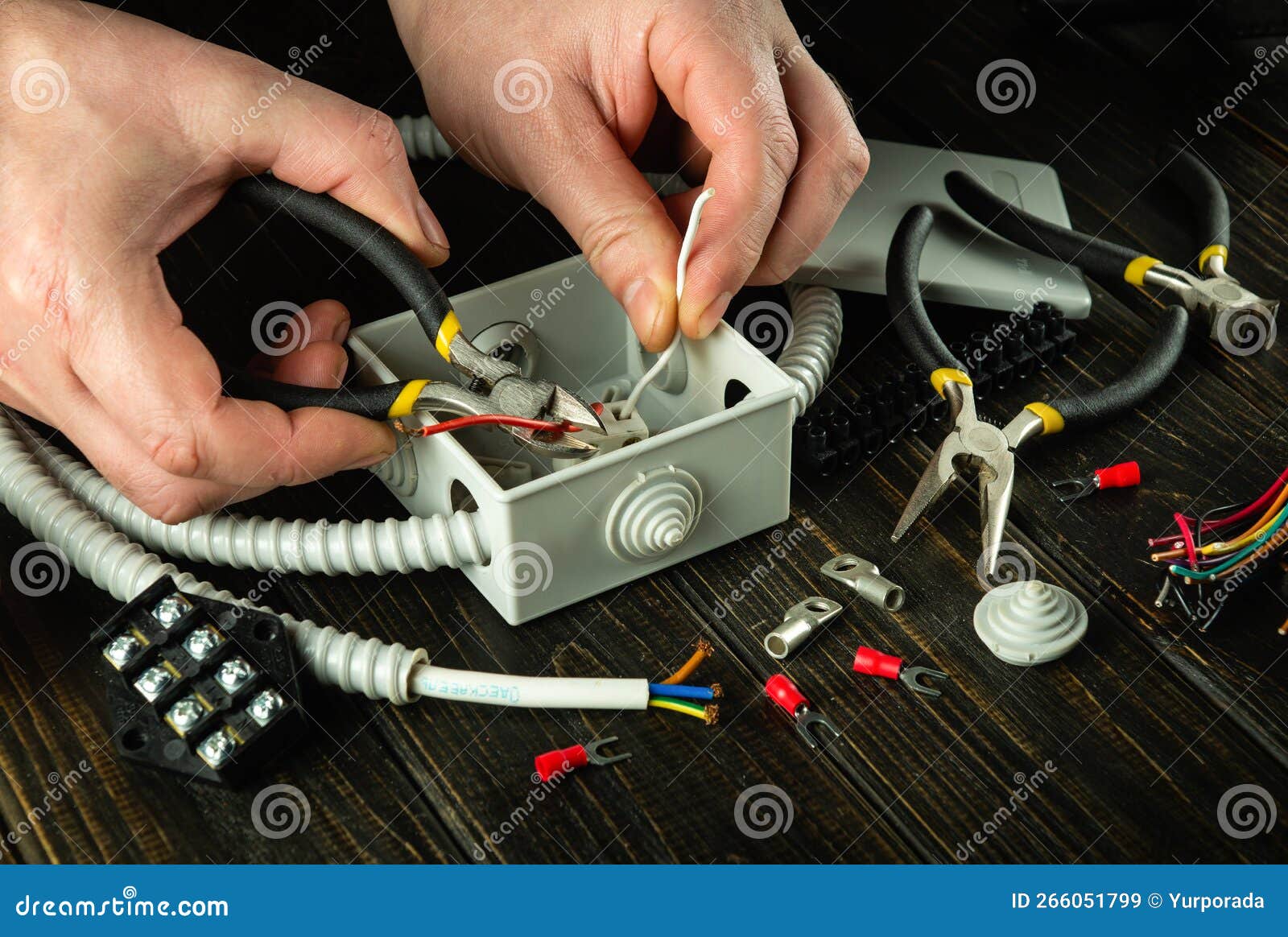 Cutting a Wire in a Gray Junction Box with Diagonal Pliers. Electrical ...