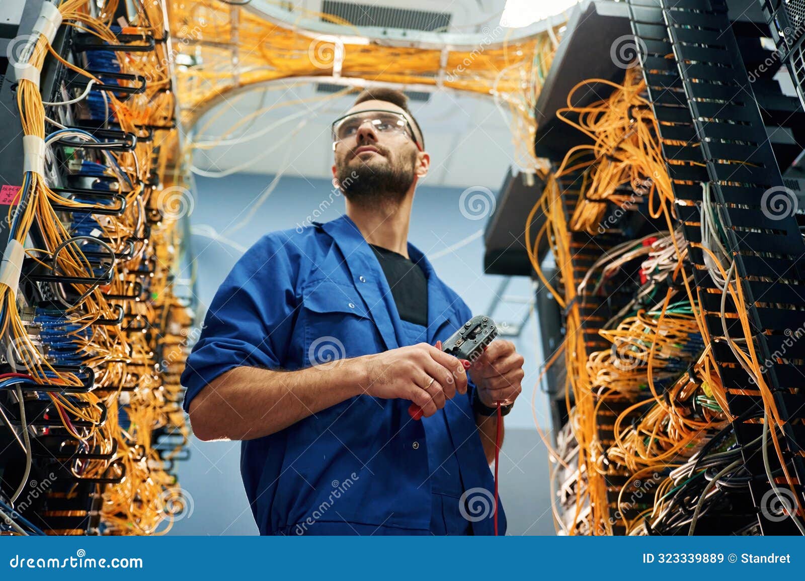 Cutting the Wire. Young Man is Working with Internet Equipment in ...