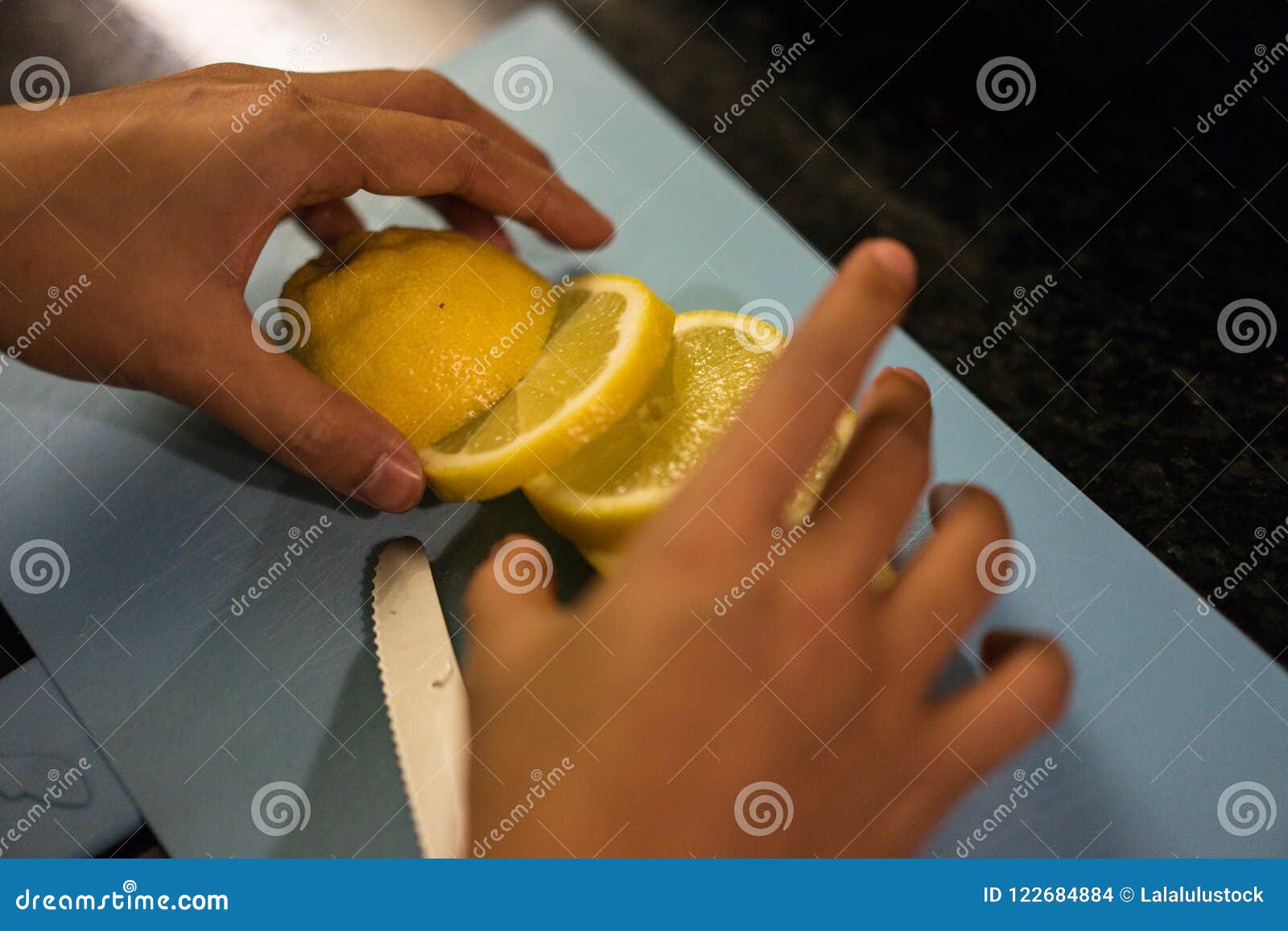 Cutting Lemon in Kitchen with Knife and Hand Stock Photo - Image of ...