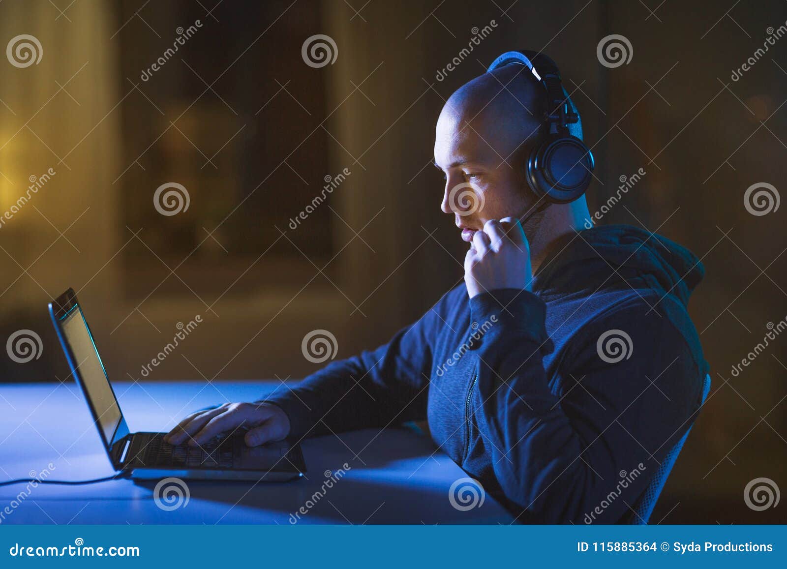 Hacker in Headset Typing on Laptop in Dark Room Stock Photo - Image of ...