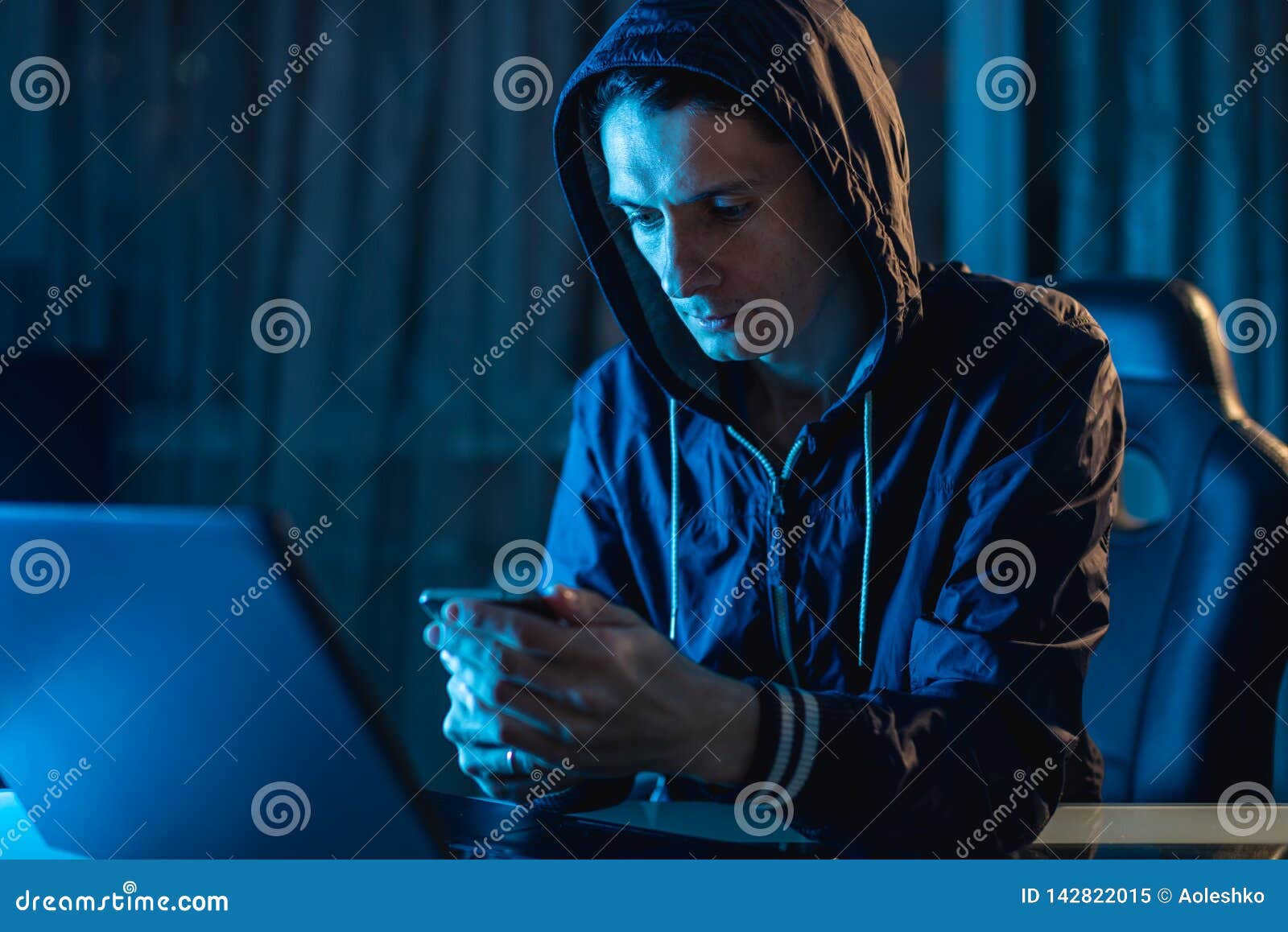Cybercriminal Hacker In The Hood Typing Program Code While Stealing Access Databases With