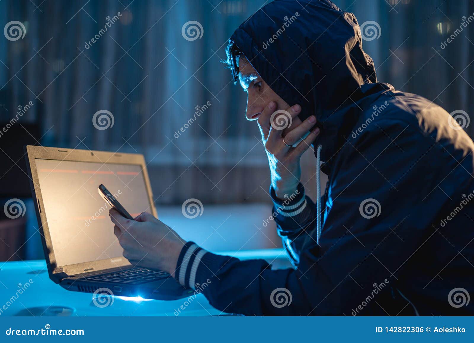 Cybercriminal In The Hood Typing Program Code While Stealing Access Databases With Passwords