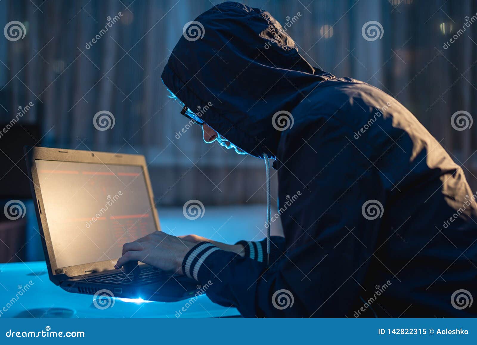 Cybercriminal In The Hood Typing Program Code While Stealing Access Databases With Passwords