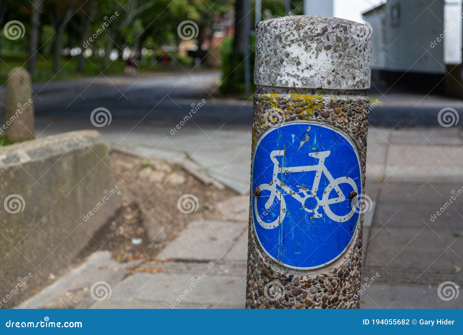 A Cycle Path Sign on an Old Wonky Bollard Next To a Cycle Lane Stock ...