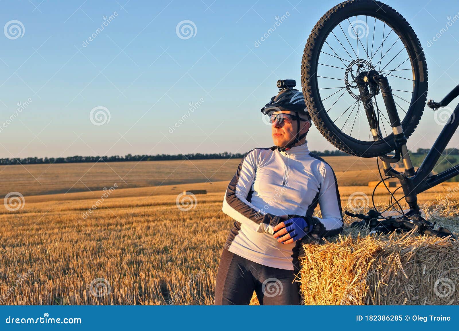 The Cyclist with the Bike Resting on the Straw in the Field Stock Image ...