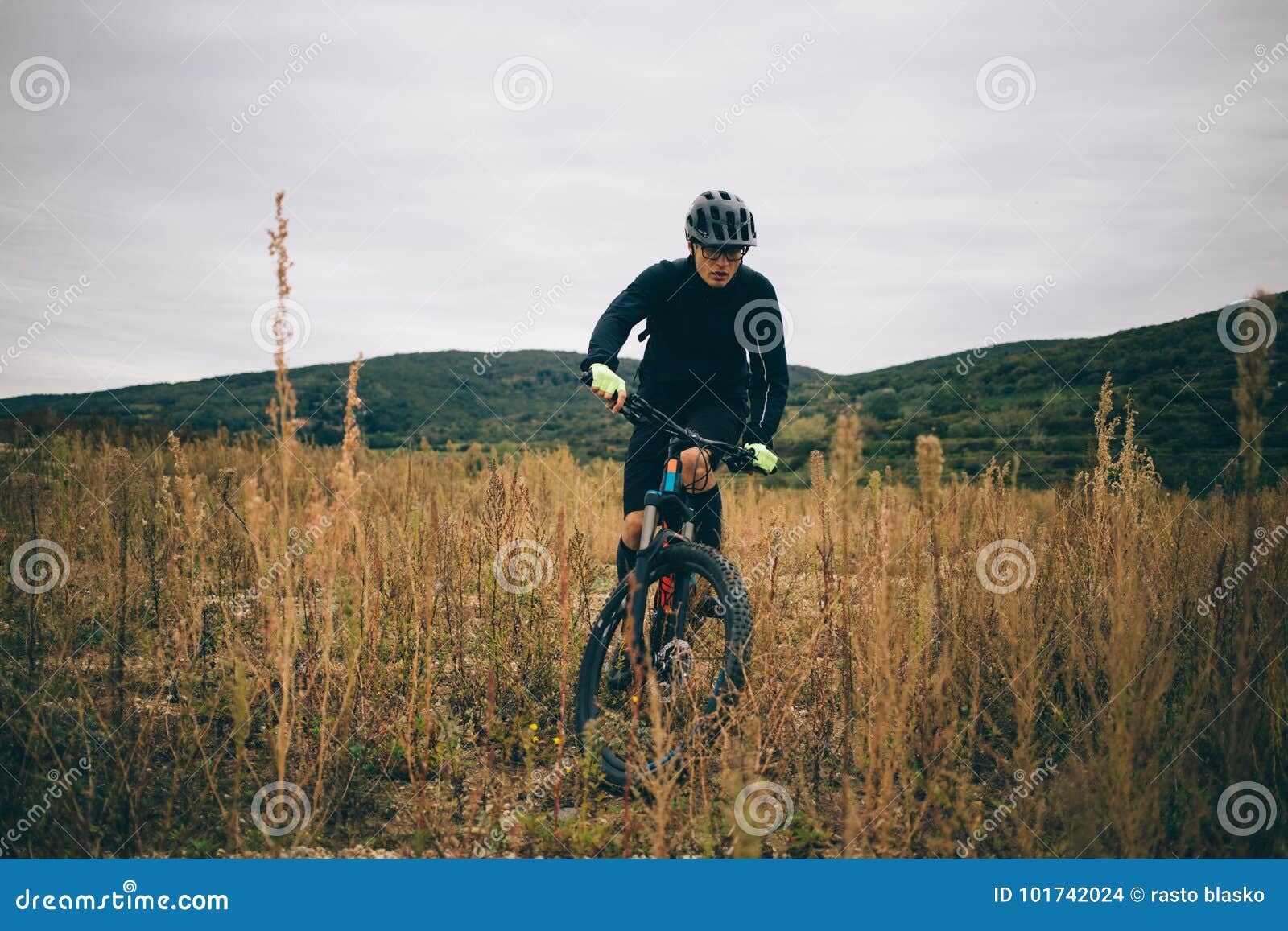 A cyclist in black stock photo. Image of path, grass - 101742024