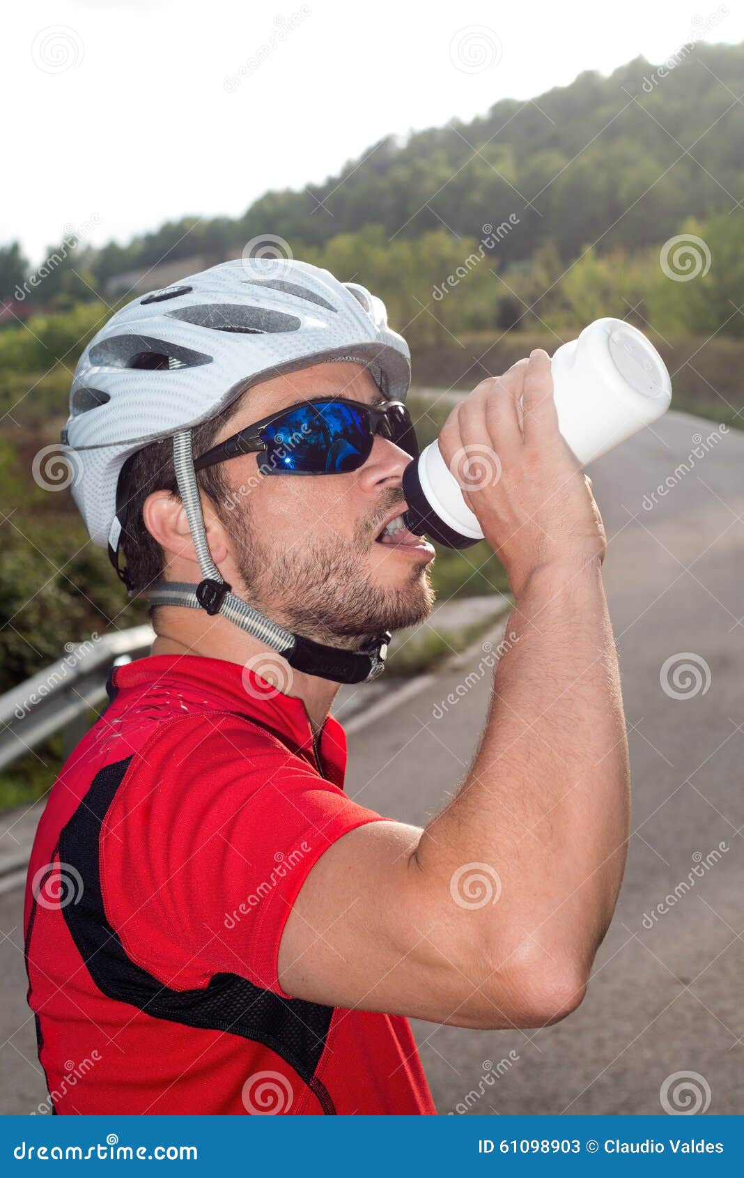 Cyclist drinks water stock image. Image of outdoors, highway - 61098903