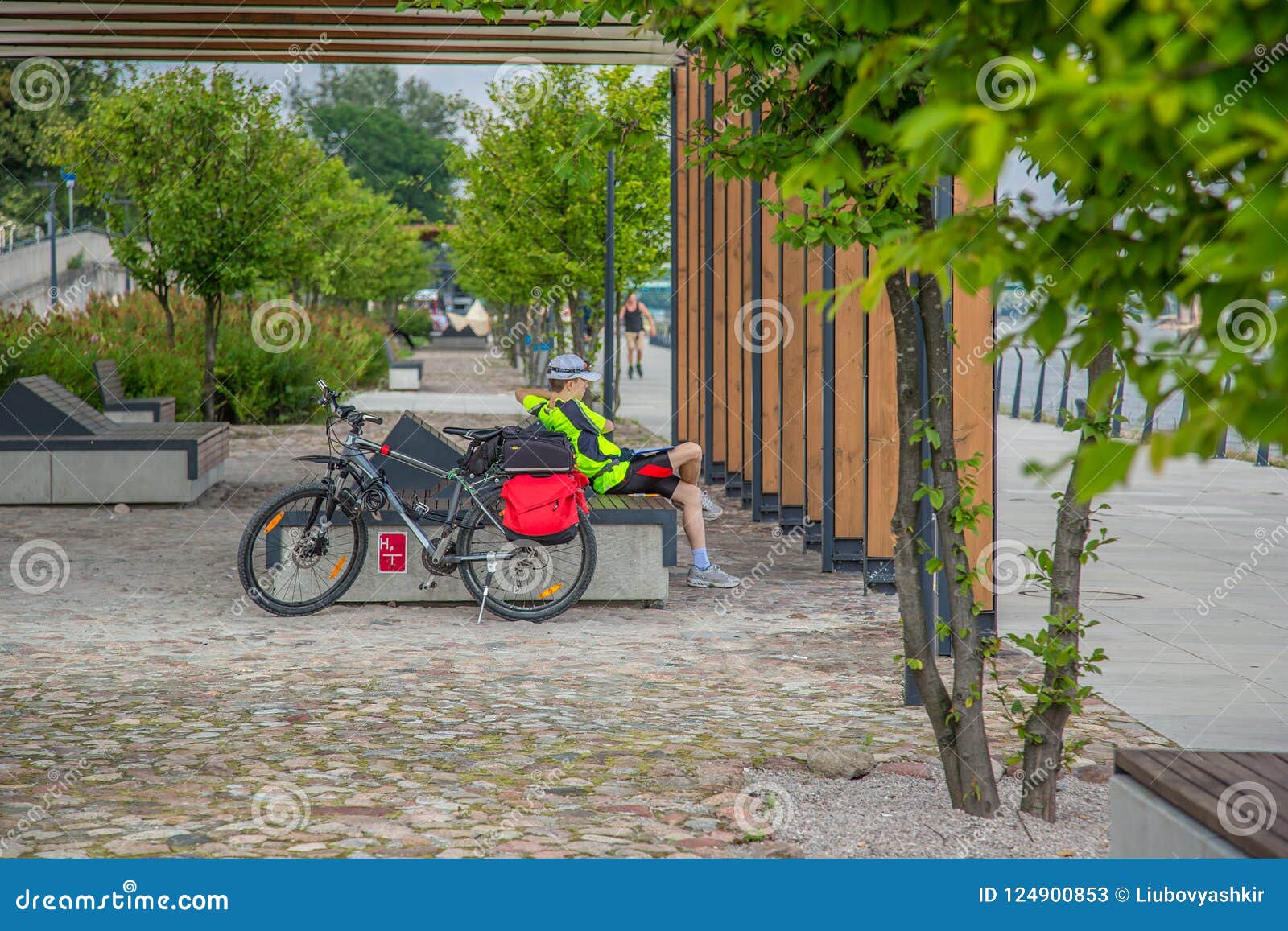 Cyclist Resting on a Bench on a Walkway Editorial Stock Photo - Image ...
