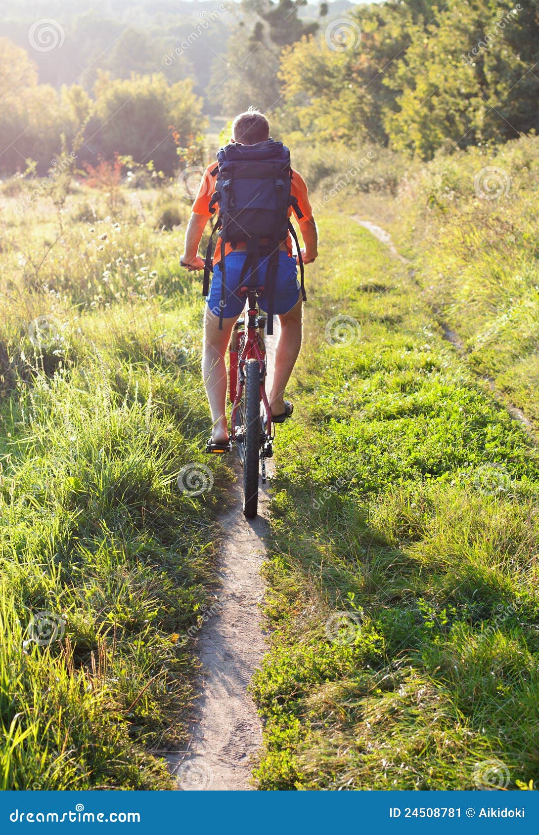 Cyclist Riding Away into the Distance on the Road Stock Image - Image ...