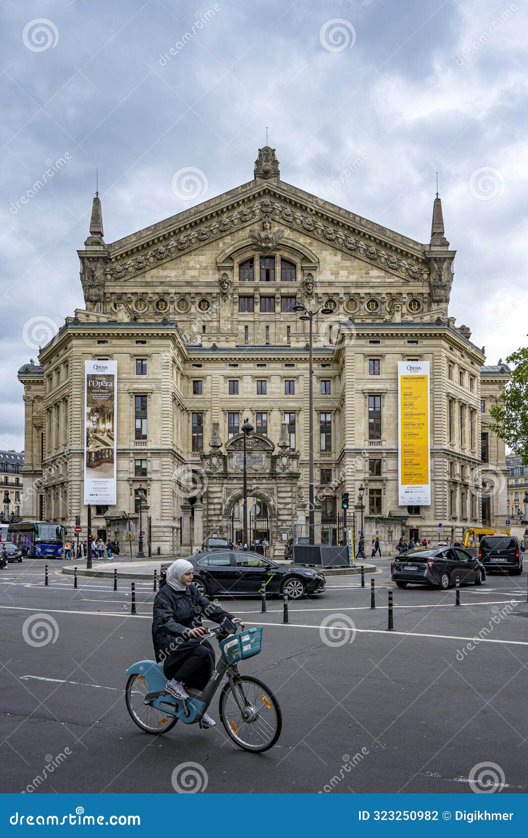 A Cyclist Running in Front of Opera Garnier Building in Paris Editorial ...