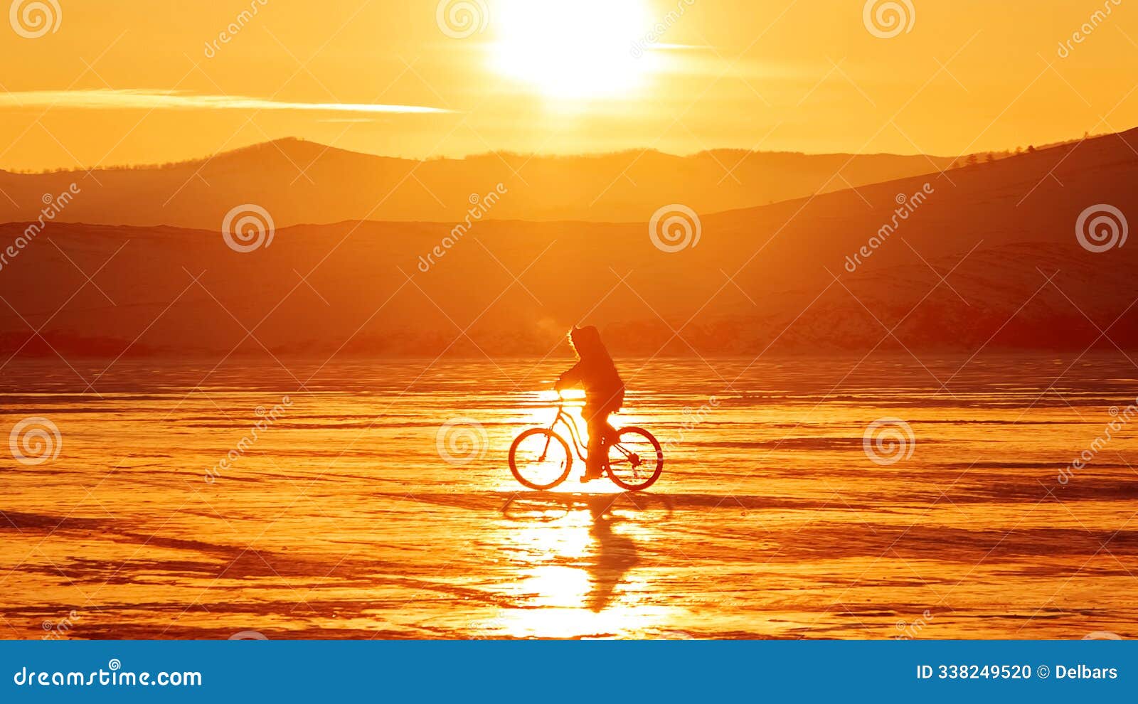 Cyclist at Sunset on Ice. Lake Baikal. Stock Photo - Image of motion ...