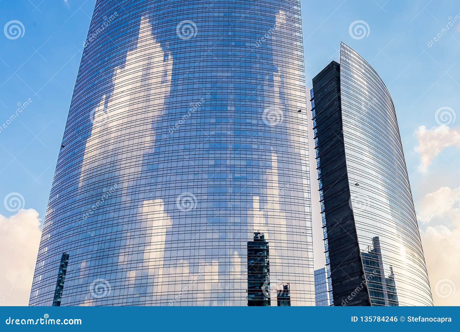 Cylindrical Skyscraper with Clouds Reflected Stock Photo - Image of ...