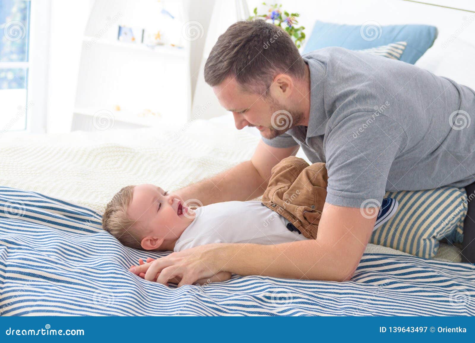 Dad and Baby Boy Playing on Bed Stock Image - Image of love, childhood ...