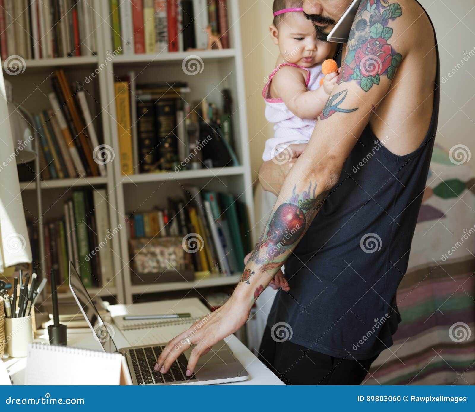 Dad Carrying His Baby and Busy Using Computer Laptop Stock Photo ...