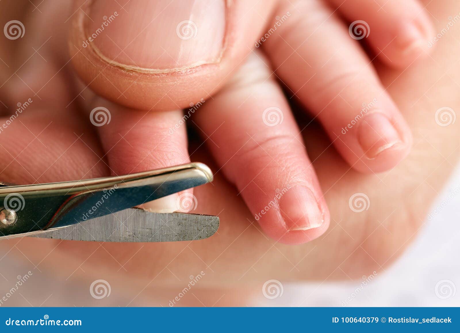 Dad cutting son`s nails stock image. Image of closeup - 100640379