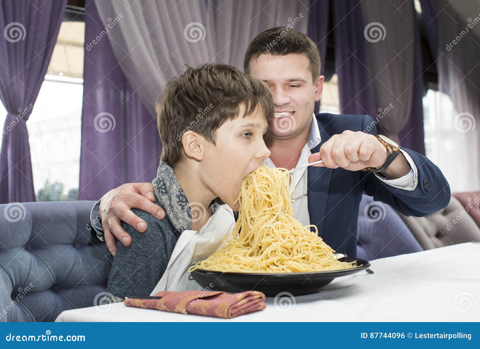 Dad Feeding His Son Spaghetti Stock Photo - Image of kids, dinner: 87744096