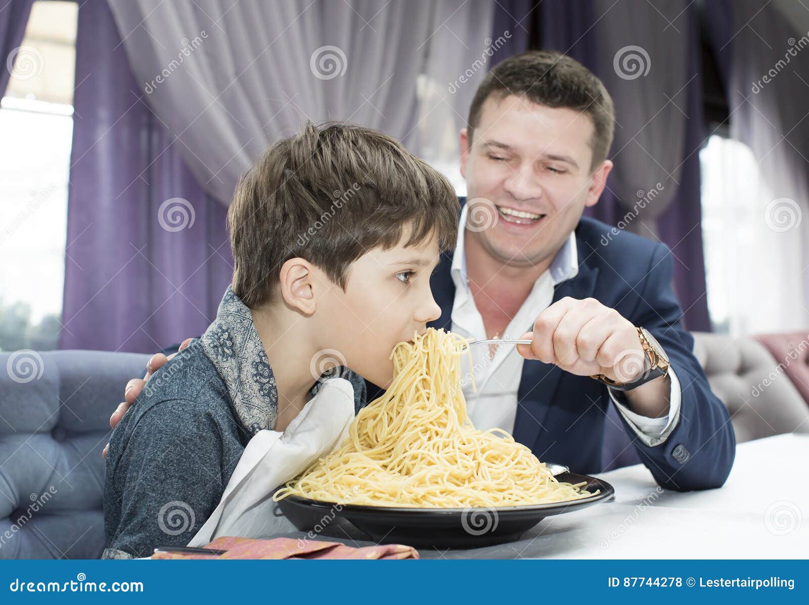 Dad Feeding His Son Spaghetti Stock Photo - Image of food, dinner: 87744278