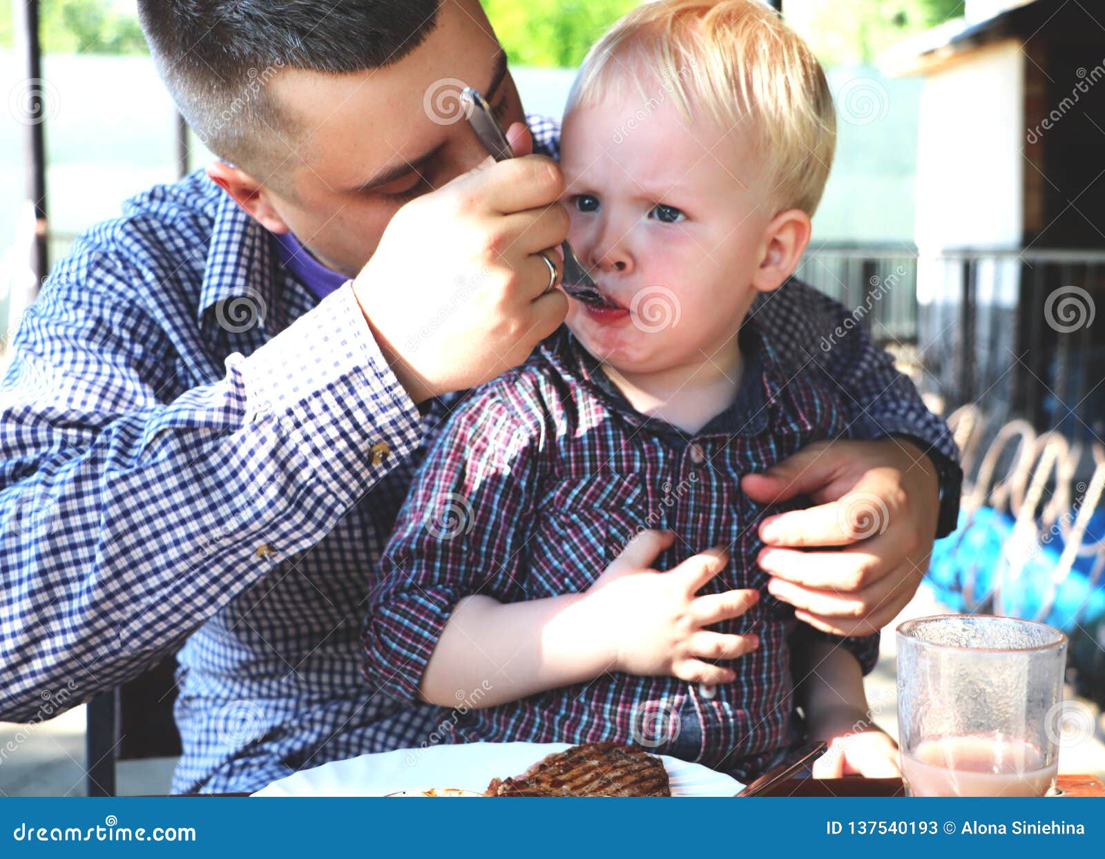 Dad Feeds the Child in a Cafe Stock Image - Image of holding, funny ...