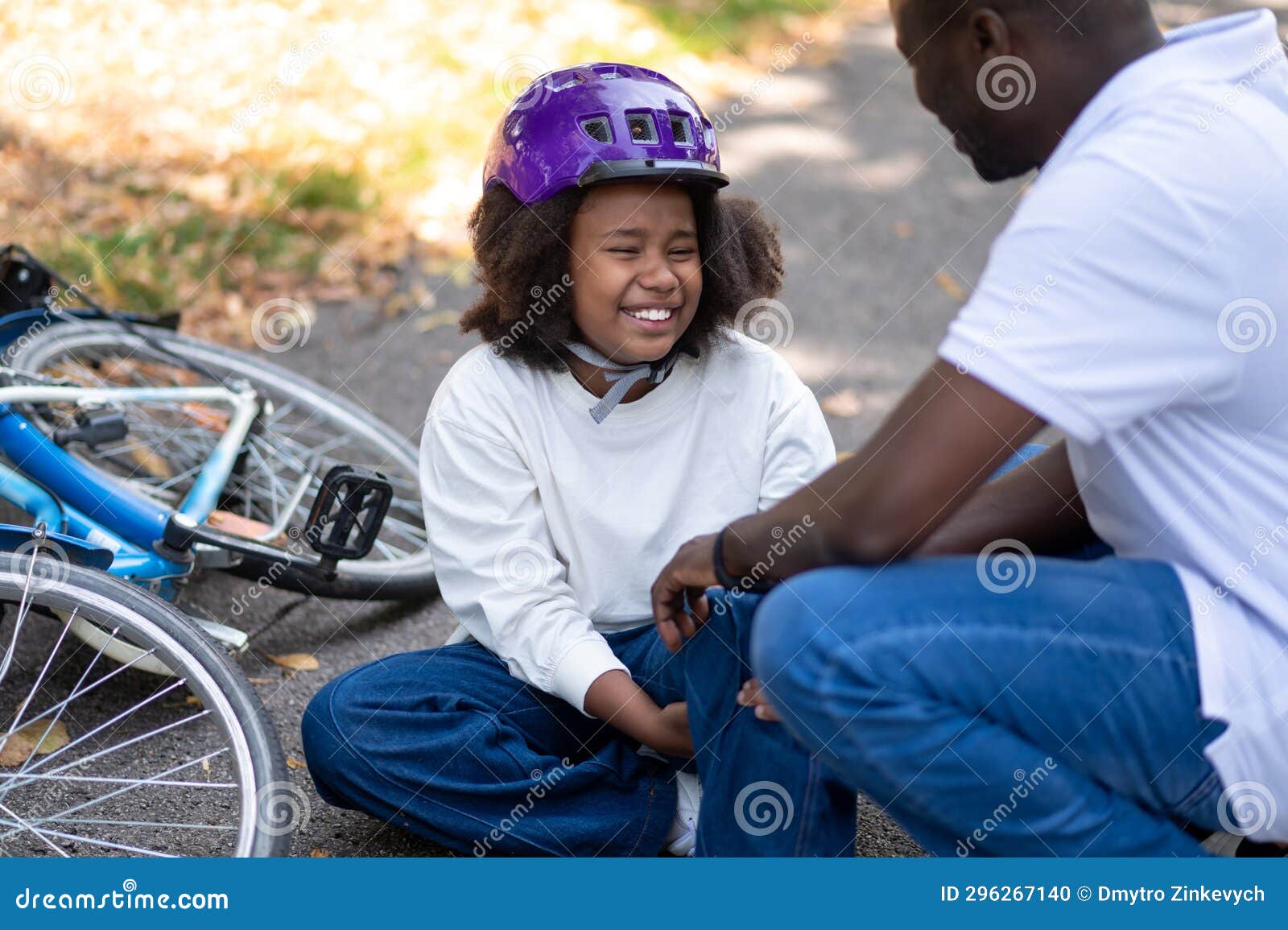 Dad Helping His Son after Falling Down from a Bike Stock Photo - Image ...