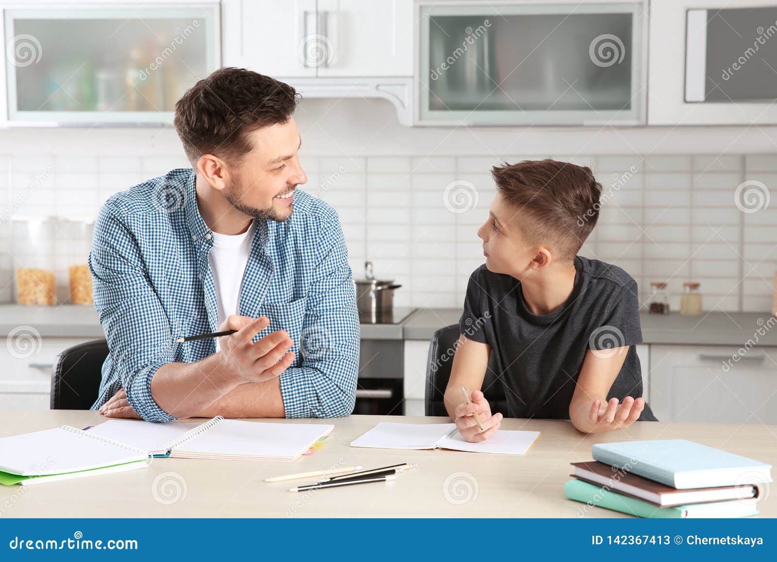 Dad Helping His Son with Homework Stock Image - Image of kitchen, learn ...