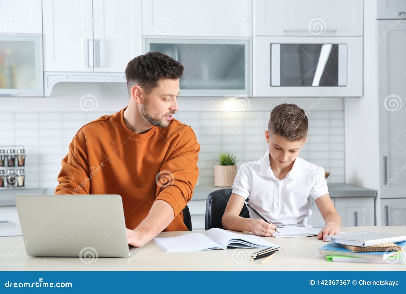 Dad Helping His Son with Homework Stock Image - Image of notebook ...