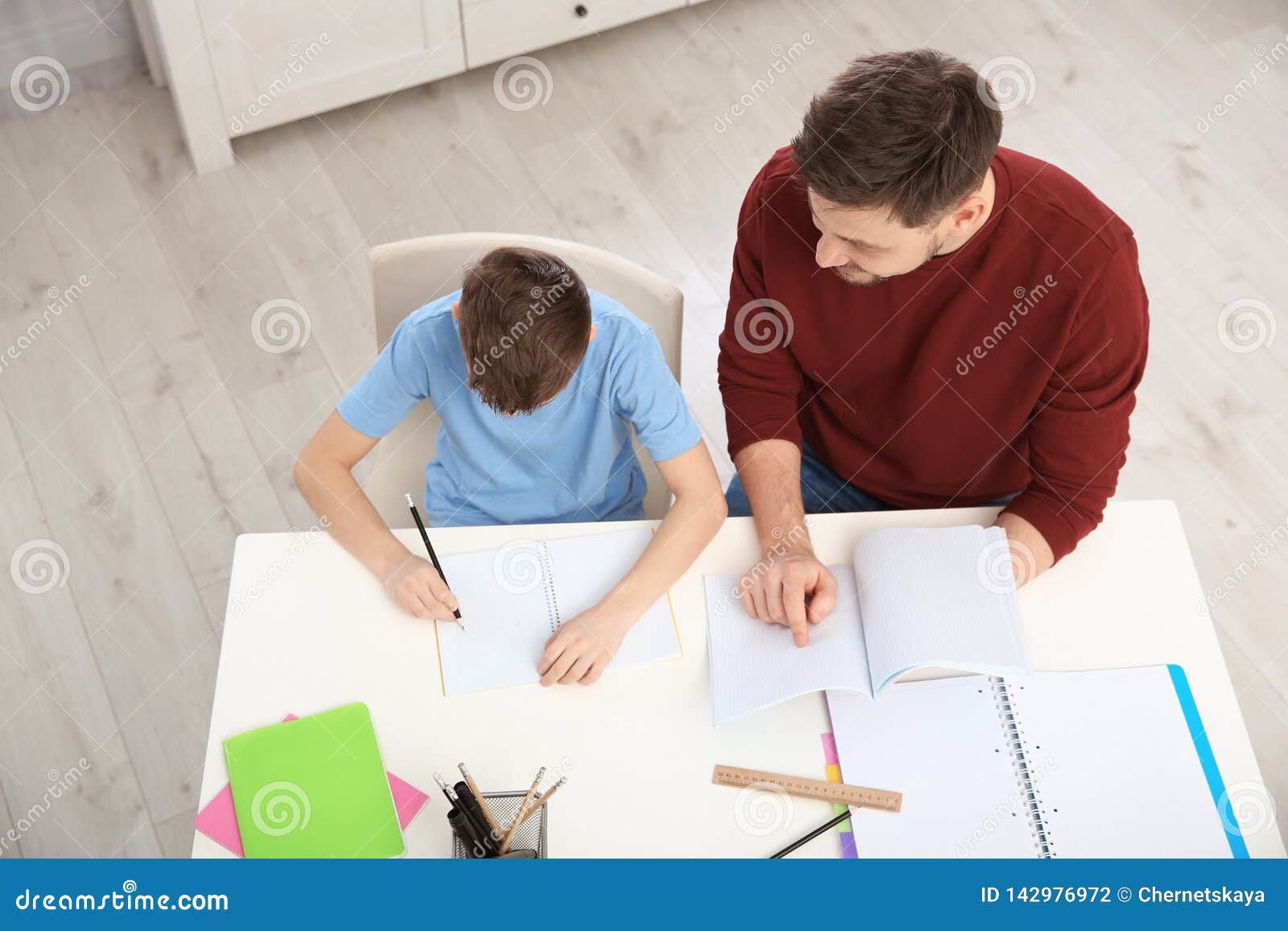 Dad Helping His Son with Homework in Room Stock Photo - Image of father ...