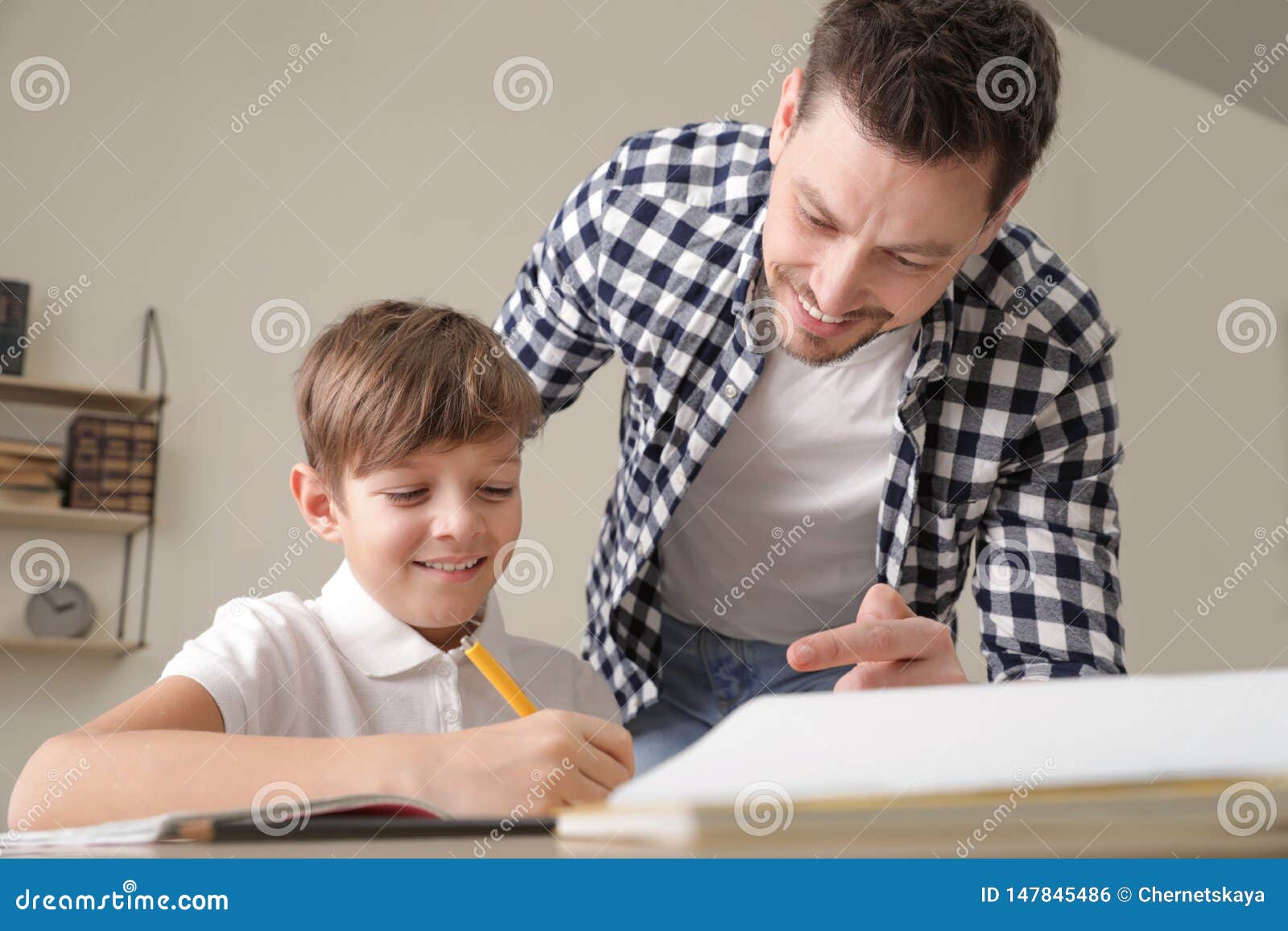 Dad Helping His Son with School Assignment Stock Photo - Image of ...