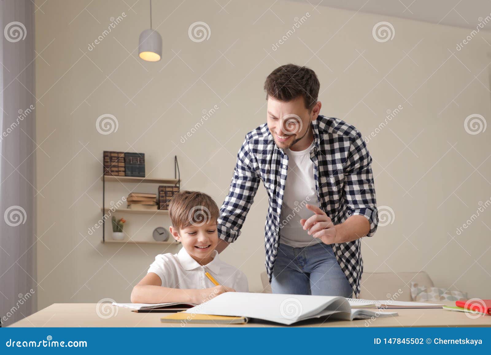 Dad Helping His Son with School Assignment Stock Photo - Image of ...